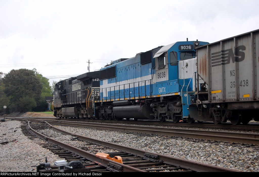 GMTX SD-60 #9036 is second out on this eastbound coal train about to cross Main St.